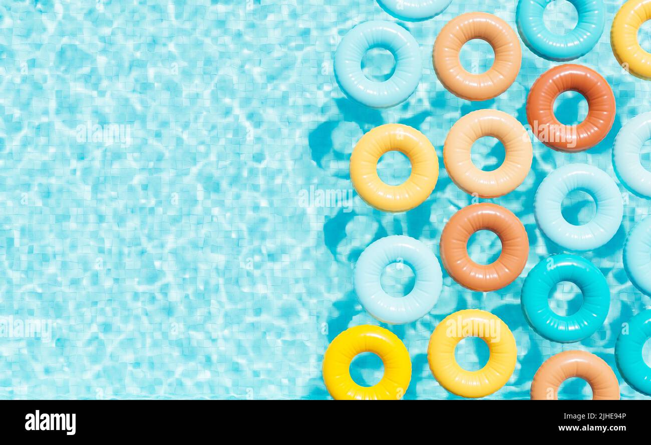 3D rendering top view of colorful inflatable swim rings floating in ...