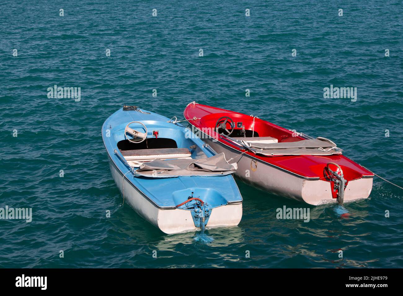 Old two boats, red and blue boats on lake. Clean water Stock Photo - Alamy