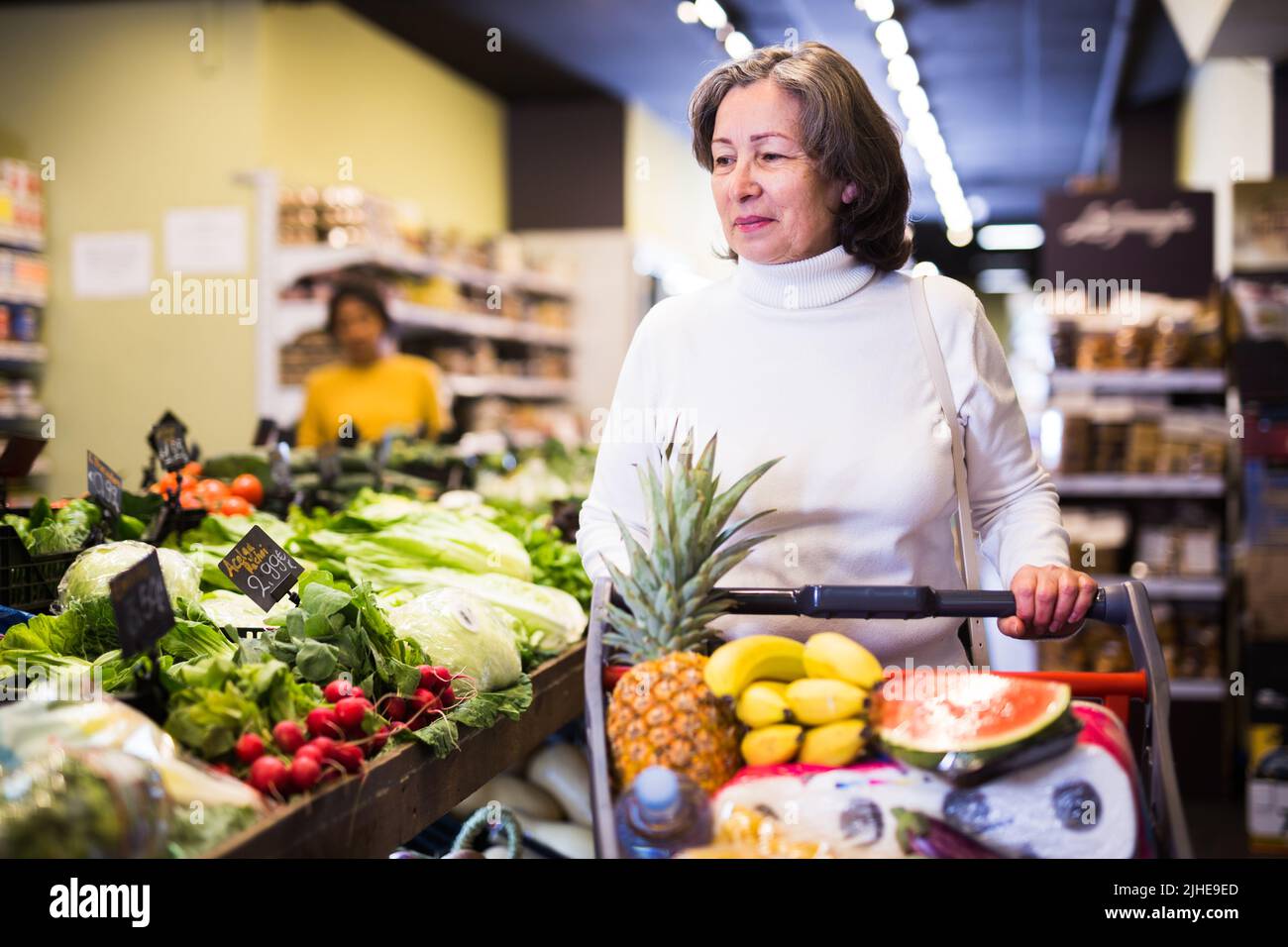 Casual woman doing shopping in grocery department of supermarket Stock ...