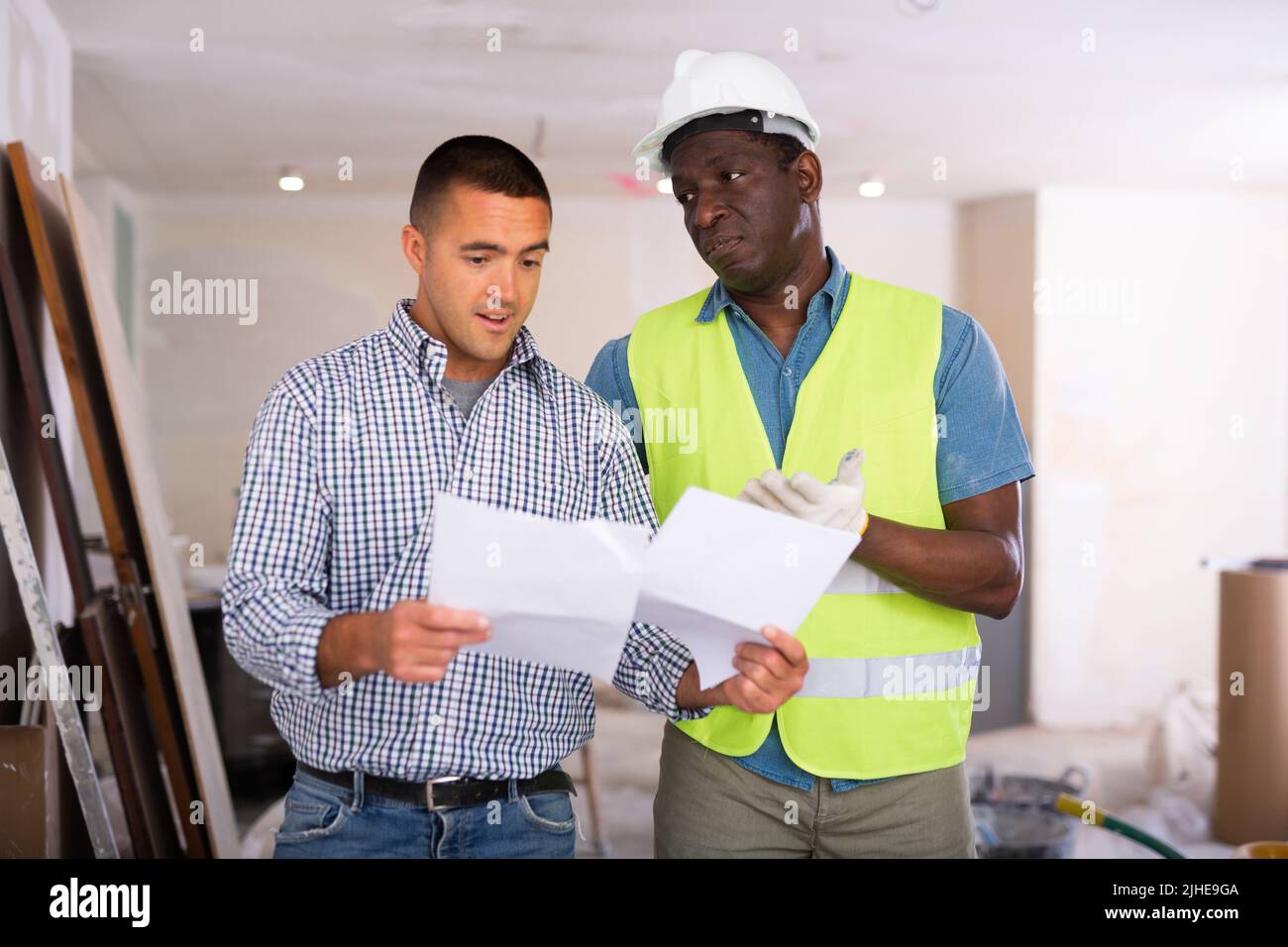 Architect and engineer having conversation about work plan in apartment ...