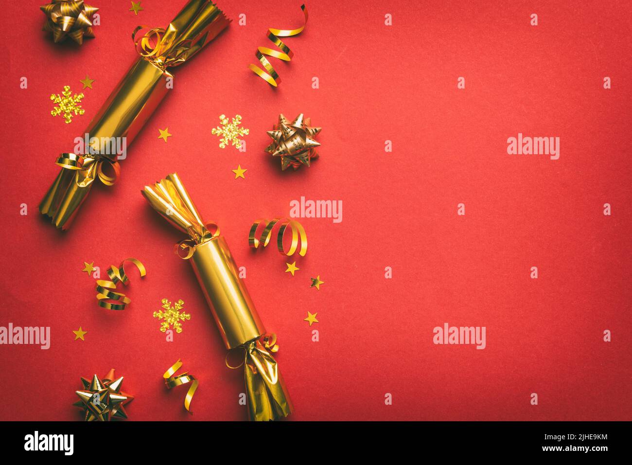 Christmas crackers with shiny confetti on color background, top view ...