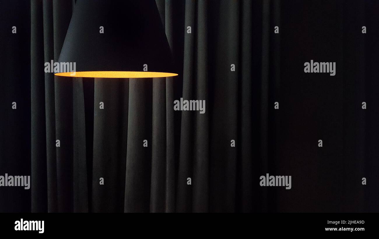 Close-up on a modern lamp against the background of the folds of ...
