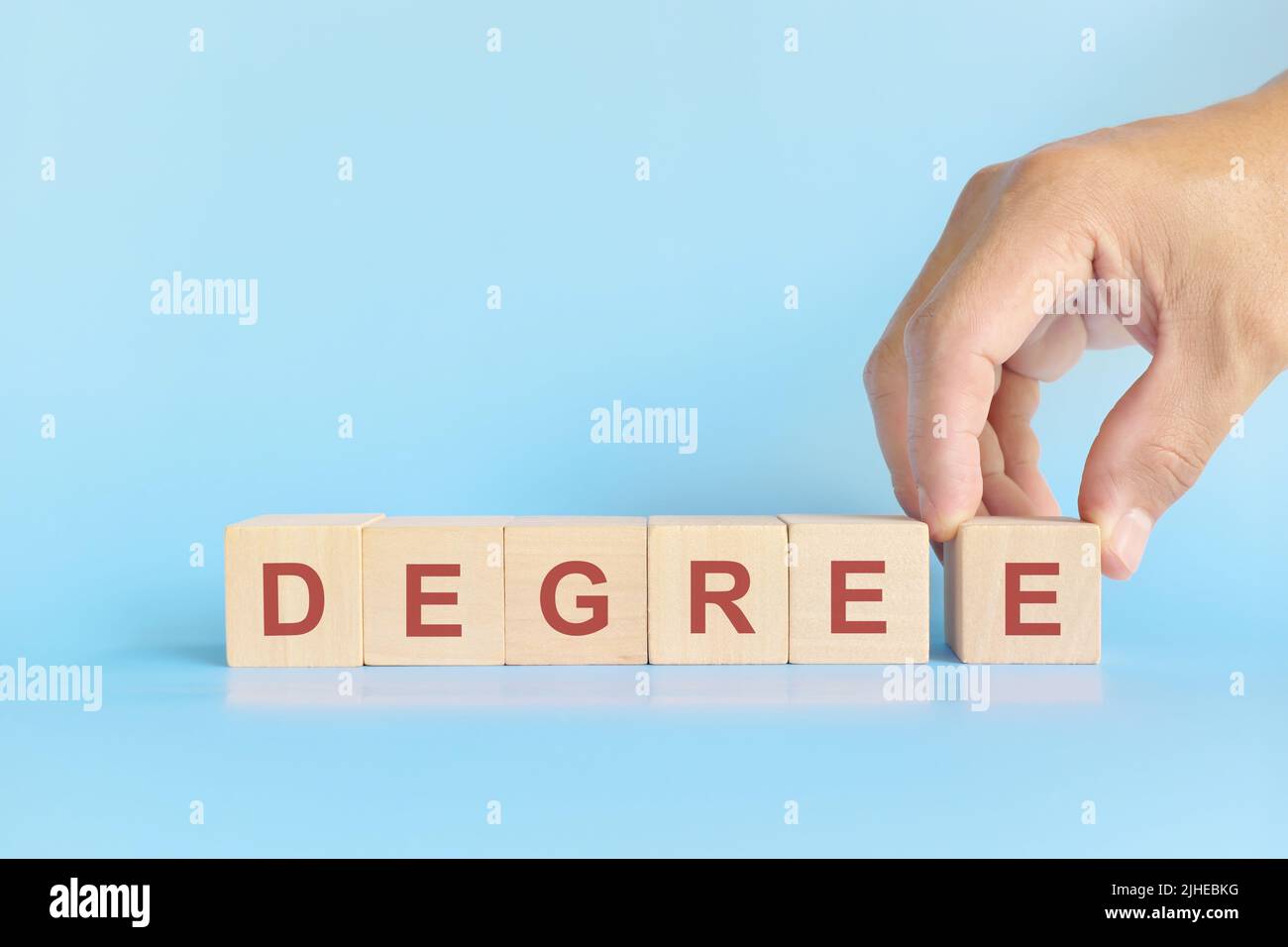 Earn a college degree concept. Human hand completing the word degree on ...