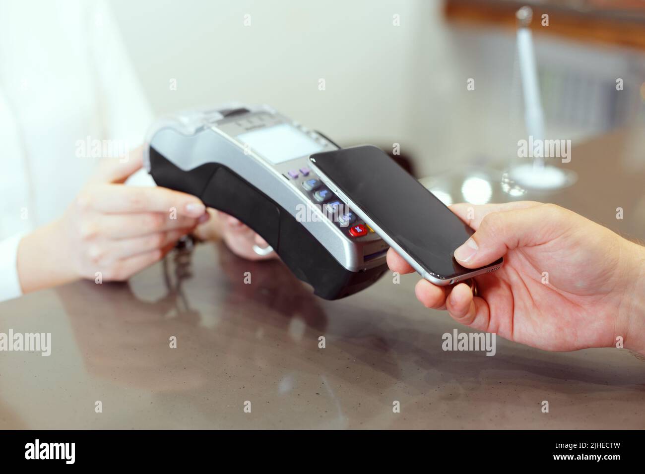 Guest at hotel reception paying with check during check-in Stock Photo ...