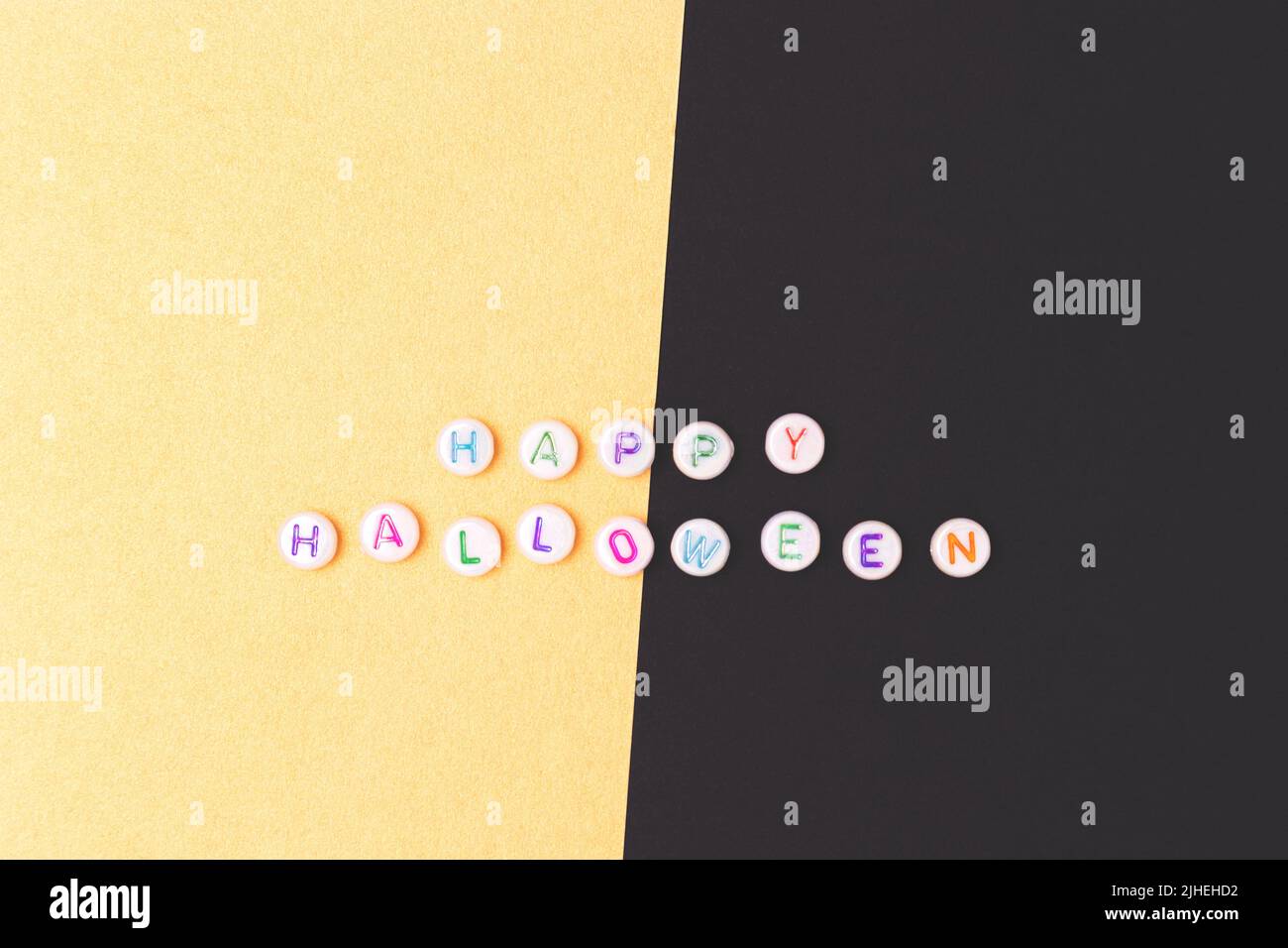 Happy halloween. Quote made of white round beads with colorful letters ...