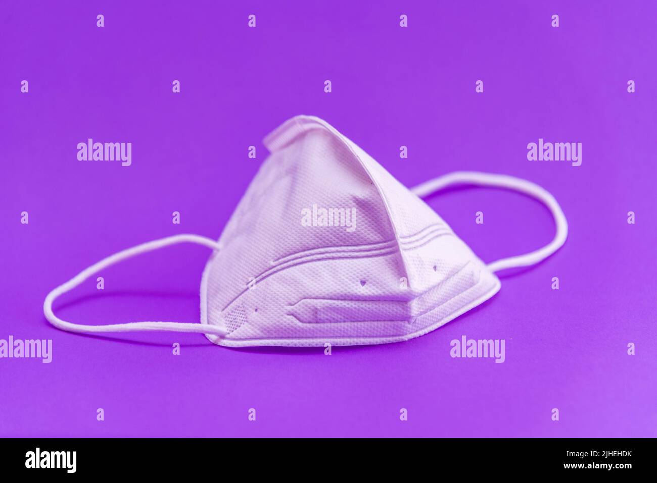 Medical protective mask flat lay on purple,veri peri pastel background ...