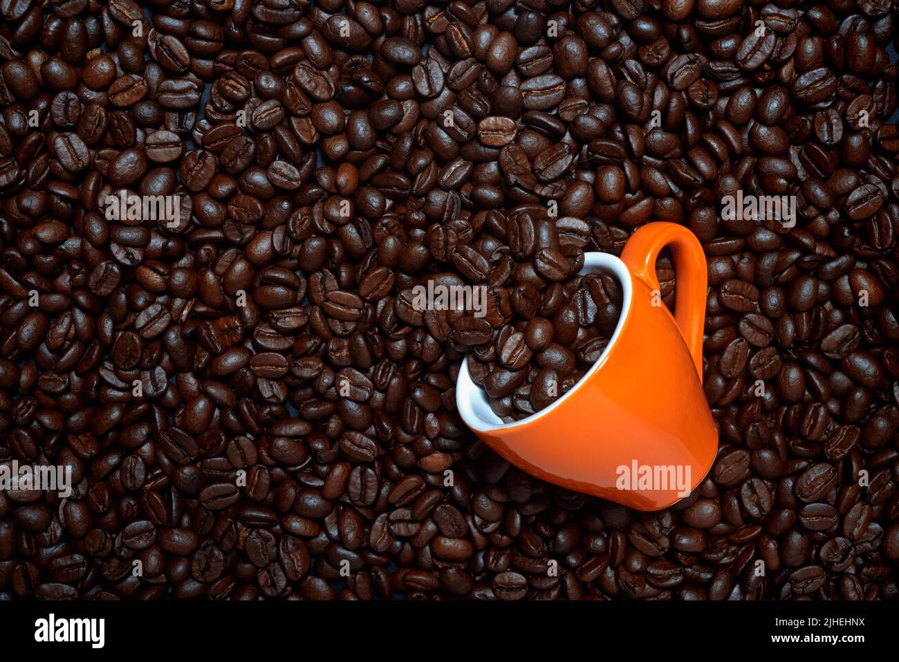 coffee cup laying on coffee beans mockup Stock Photo - Alamy