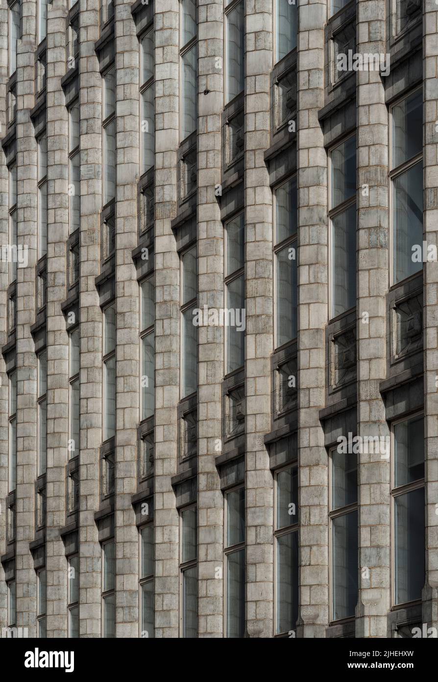 City office building with stone cladding. Abstract parallel lines ...