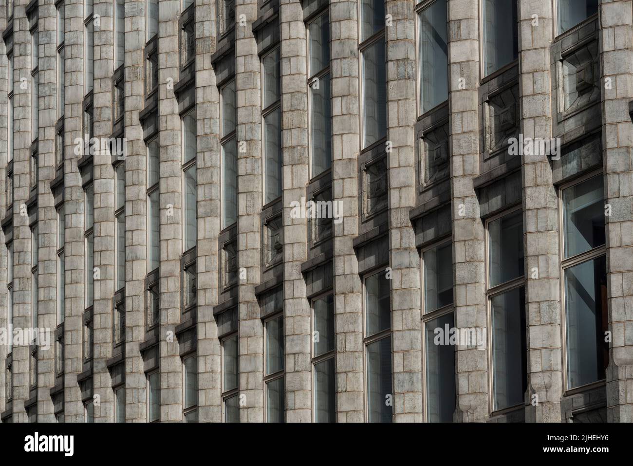 City office building with stone cladding. Abstract parallel lines ...