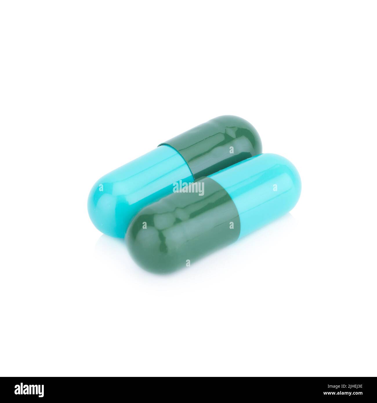 Two capsule color green and blue isolated on white background Stock ...