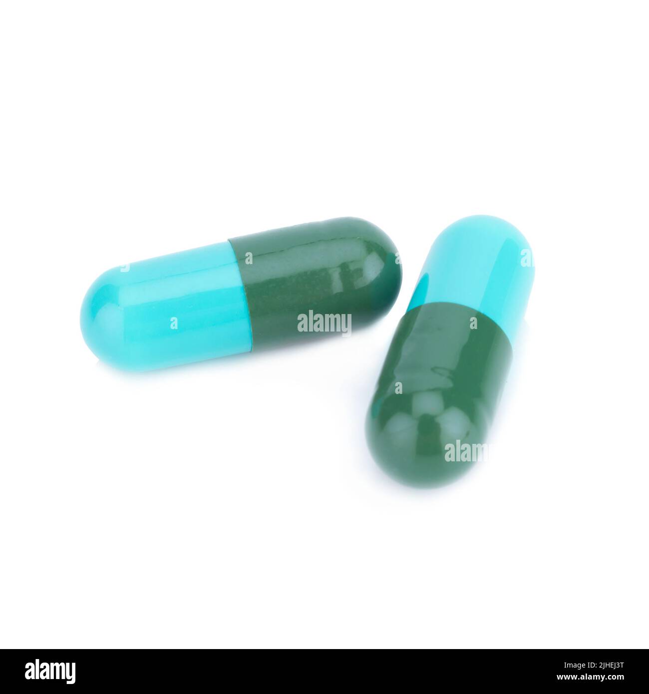 Two capsule color green and blue isolated on white background Stock ...