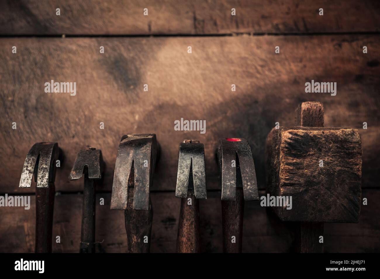 collection of vintage woodworking tools on a rough workbench and blank ...