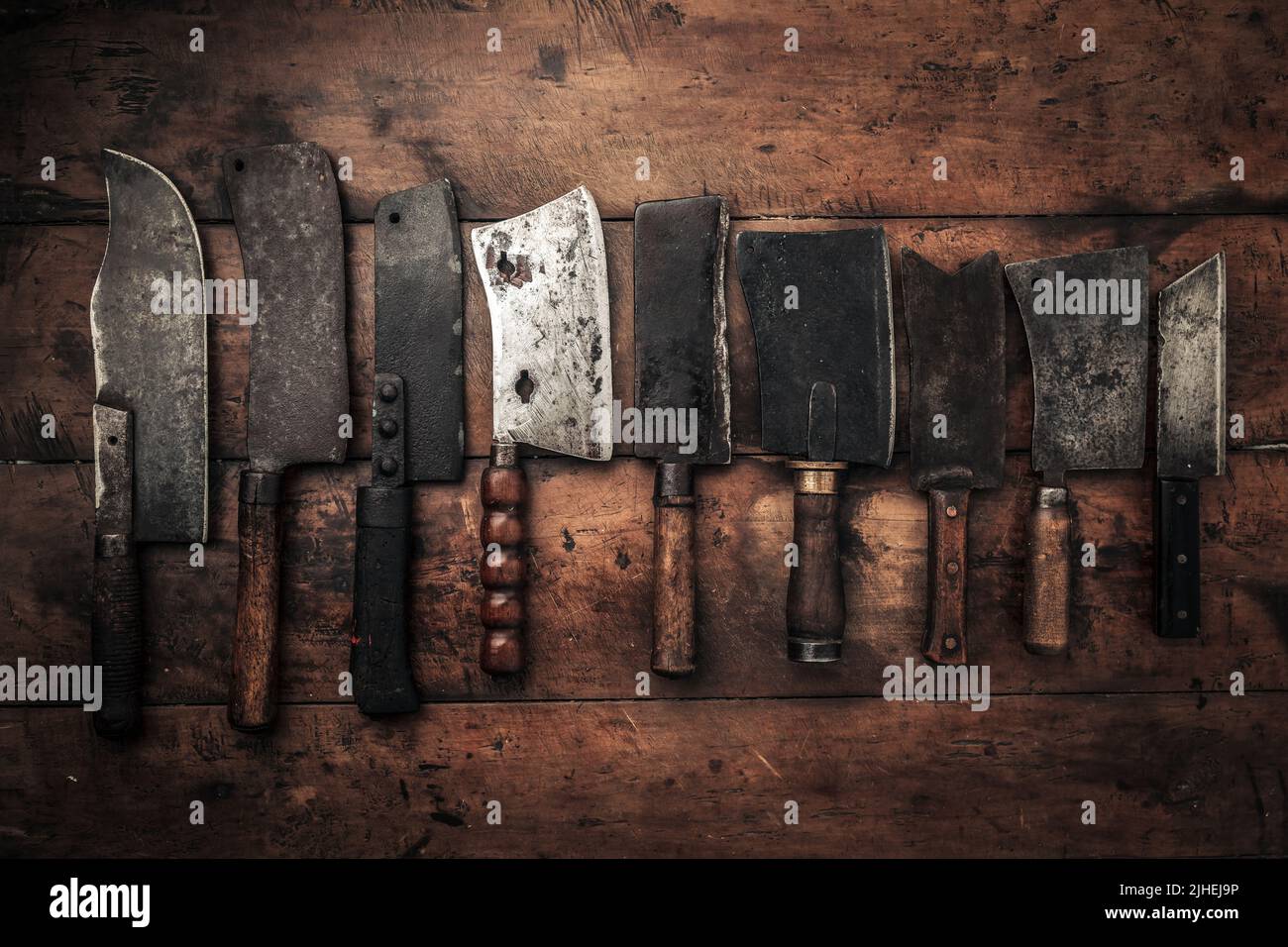 set of different types of carbon steel butchers on wooden table ...