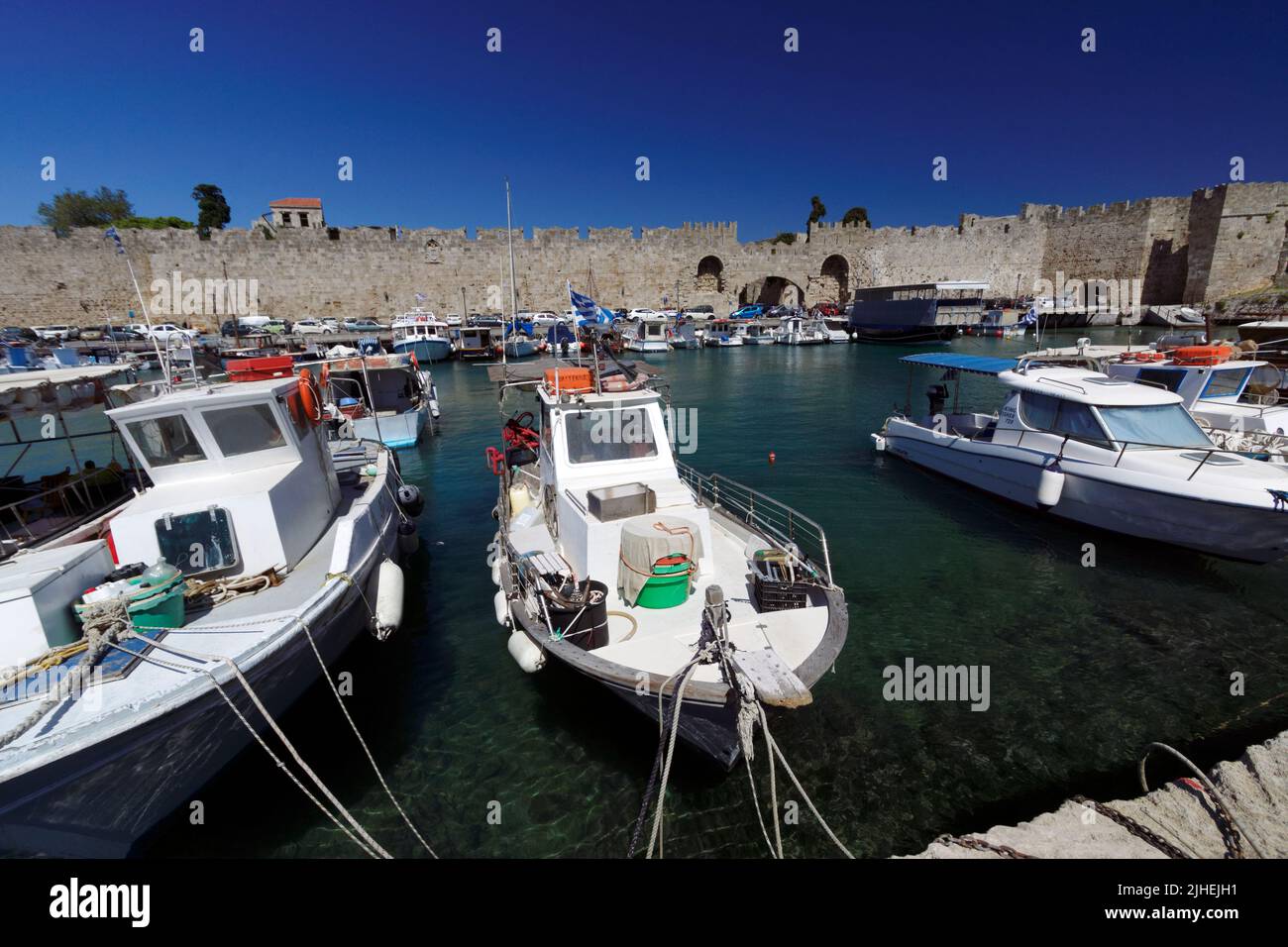 Boats in Rhodes Kolona Harbour with the Old Town Walls in the ...
