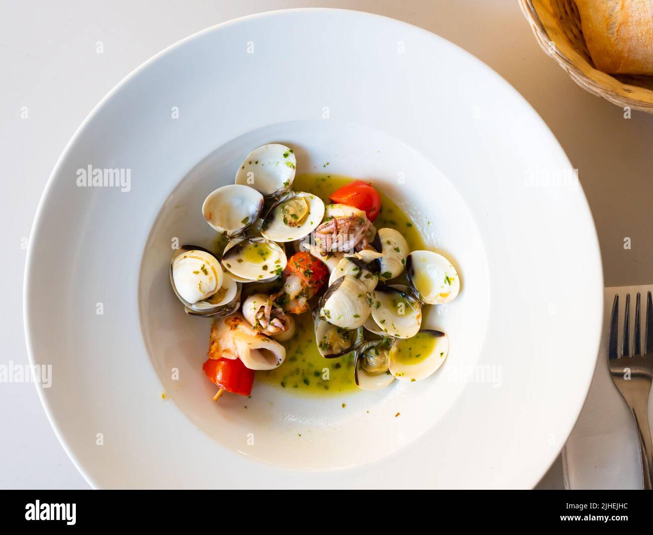 Squid skewer with garlic and clams Stock Photo - Alamy