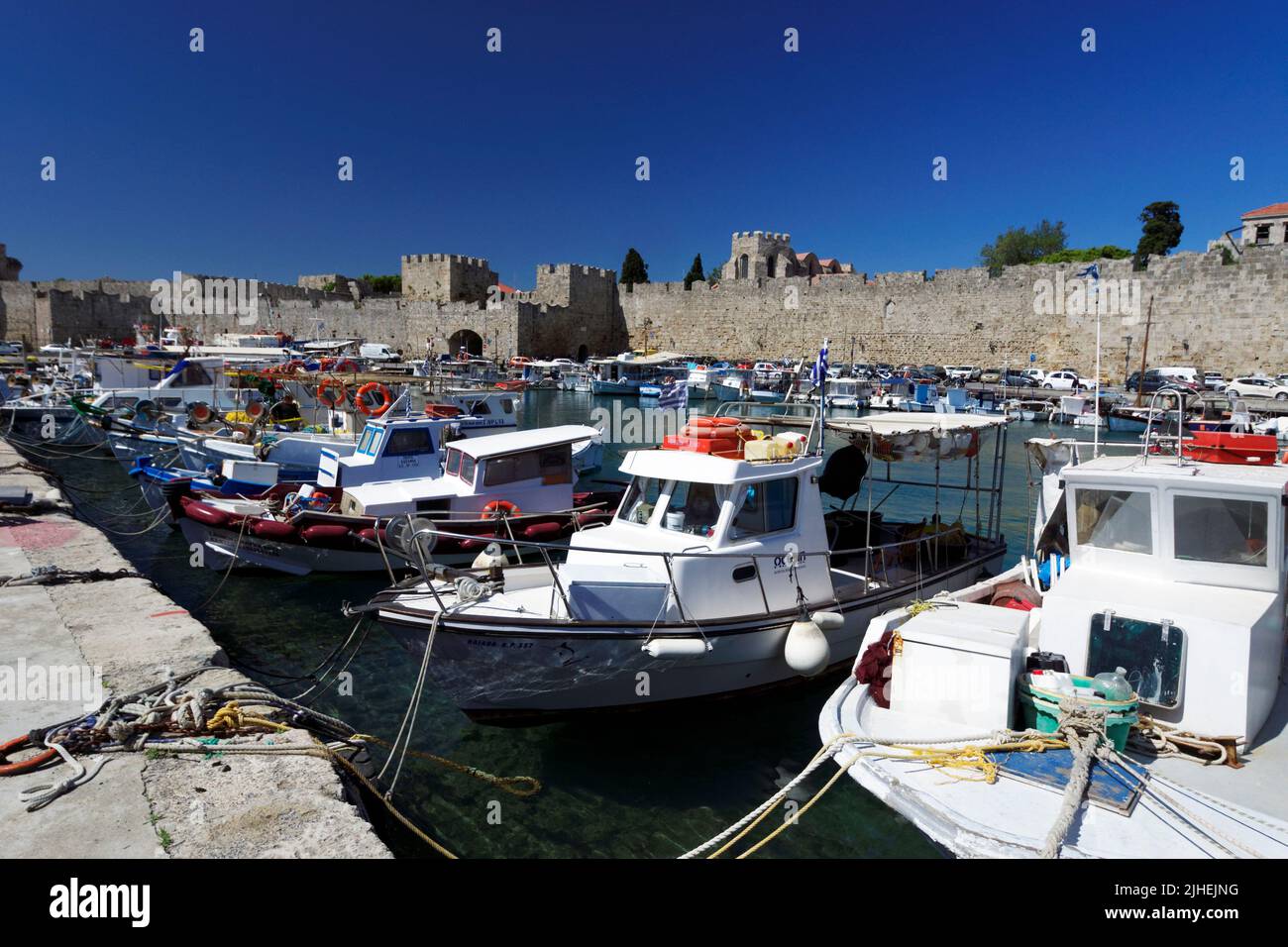 Boats in Rhodes Kolona Harbour with the Old Town Walls in the ...