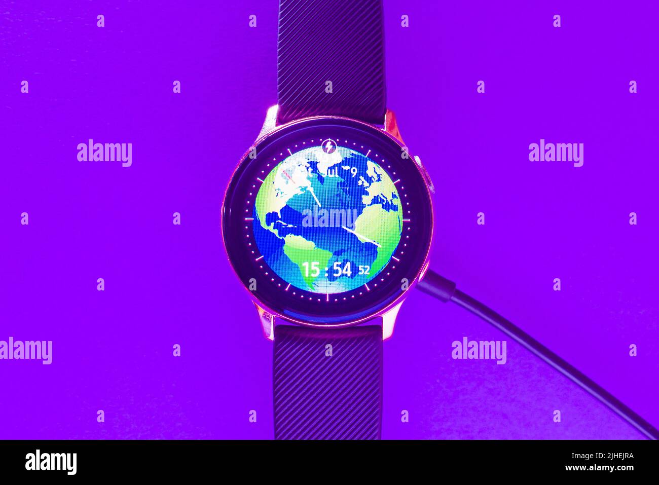 Smart watch on wireless charging with on-screen.Purple,veri peri neon ...