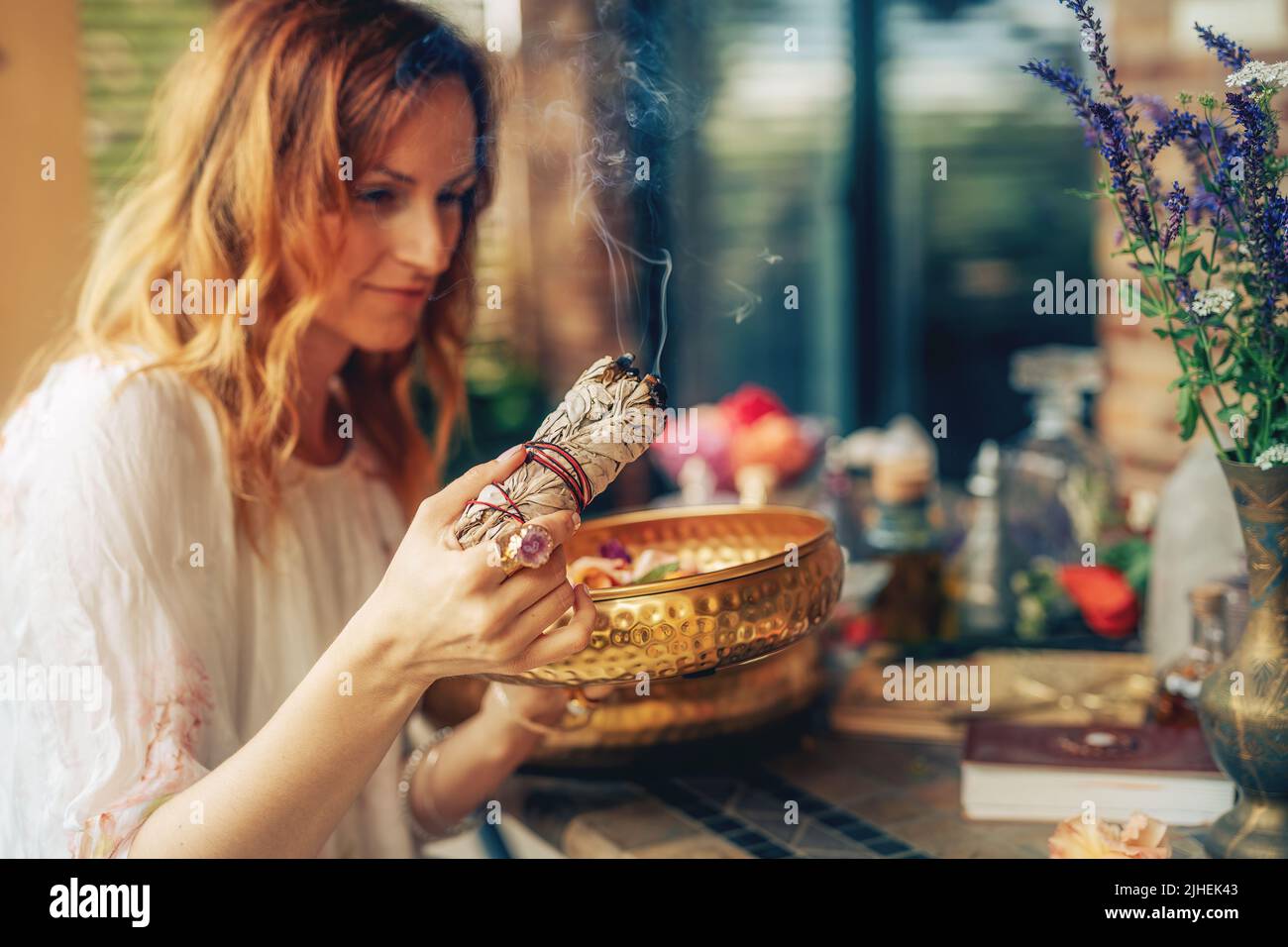 incense in a woman hand, ceremony space Stock Photo - Alamy