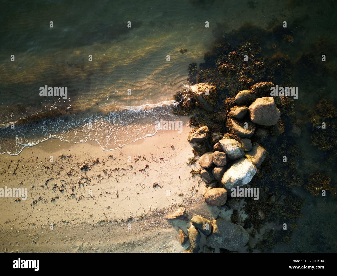An aerial view of stones on the dirty sandy beach Stock Photo - Alamy