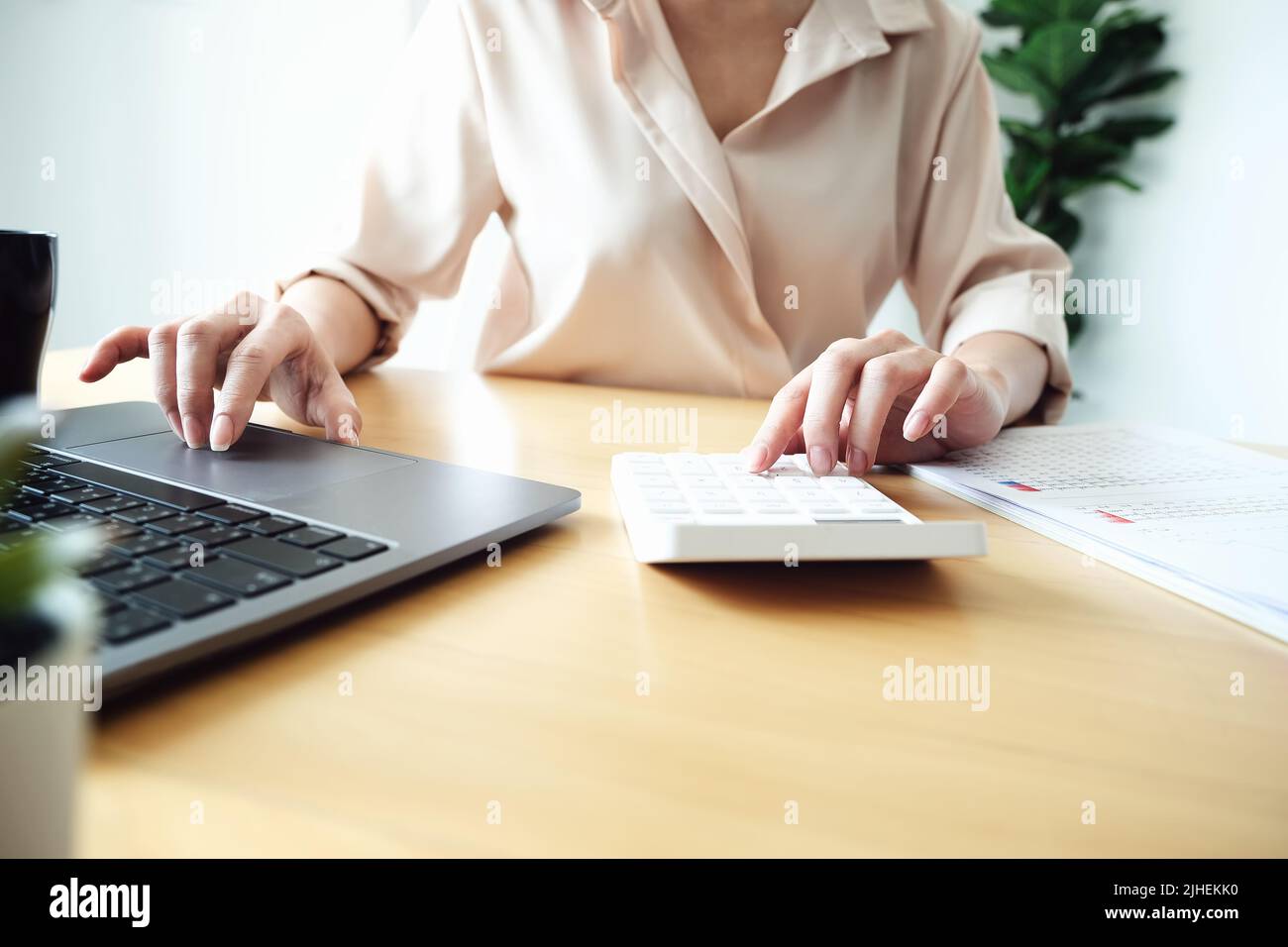 Business woman using calculator to review balance sheet annual using ...