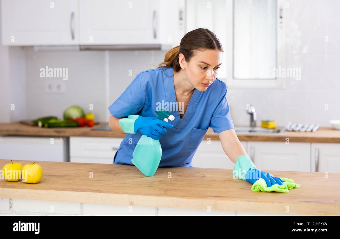 Housewife using rag to wash table Stock Photo - Alamy