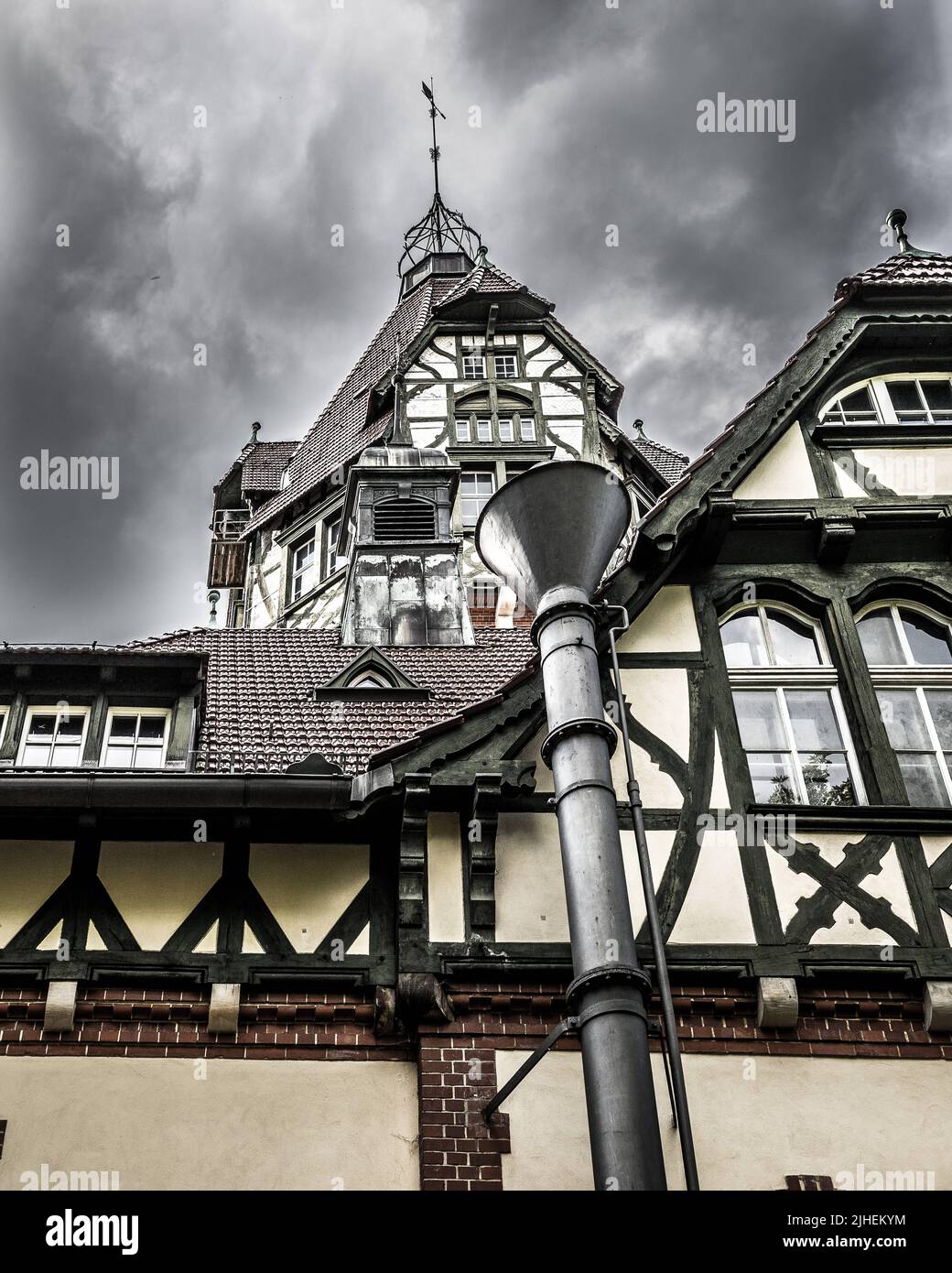 An spire leading to an atmospheric grey clouded sky. BEELITZ, GERMANY ...