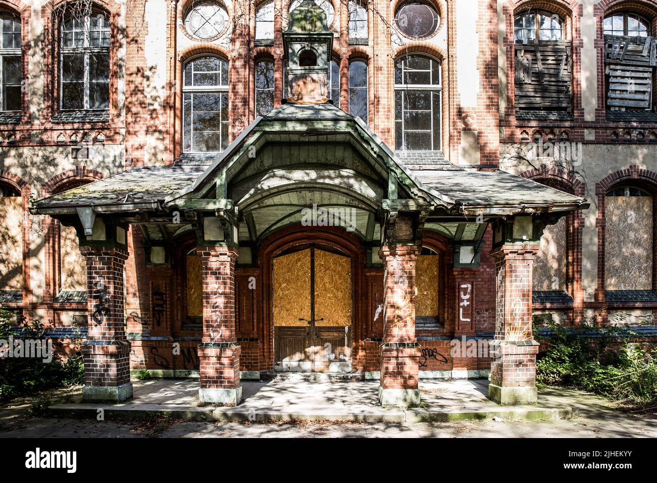 The boarded up entrance to one of the hospital's abandoned buildings ...