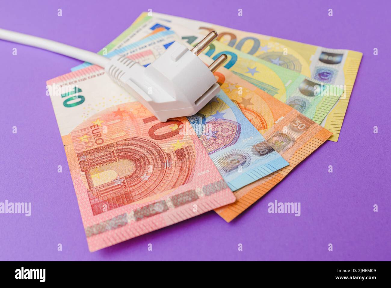 Electric plug,euro paper money banknotes.Purple indoors background ...
