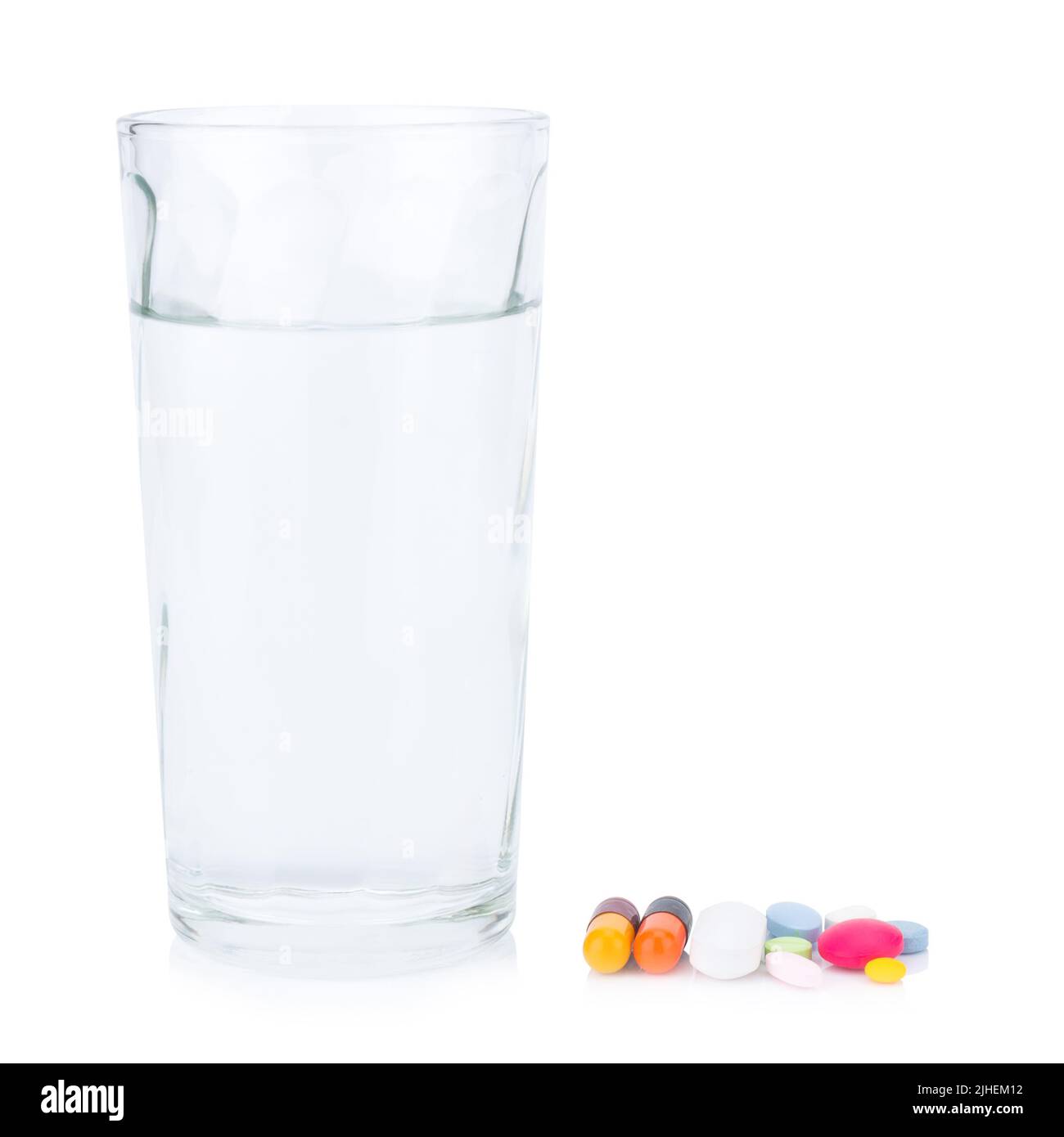 water glass. pill and capsule various colors. Take a medicine. isolated ...