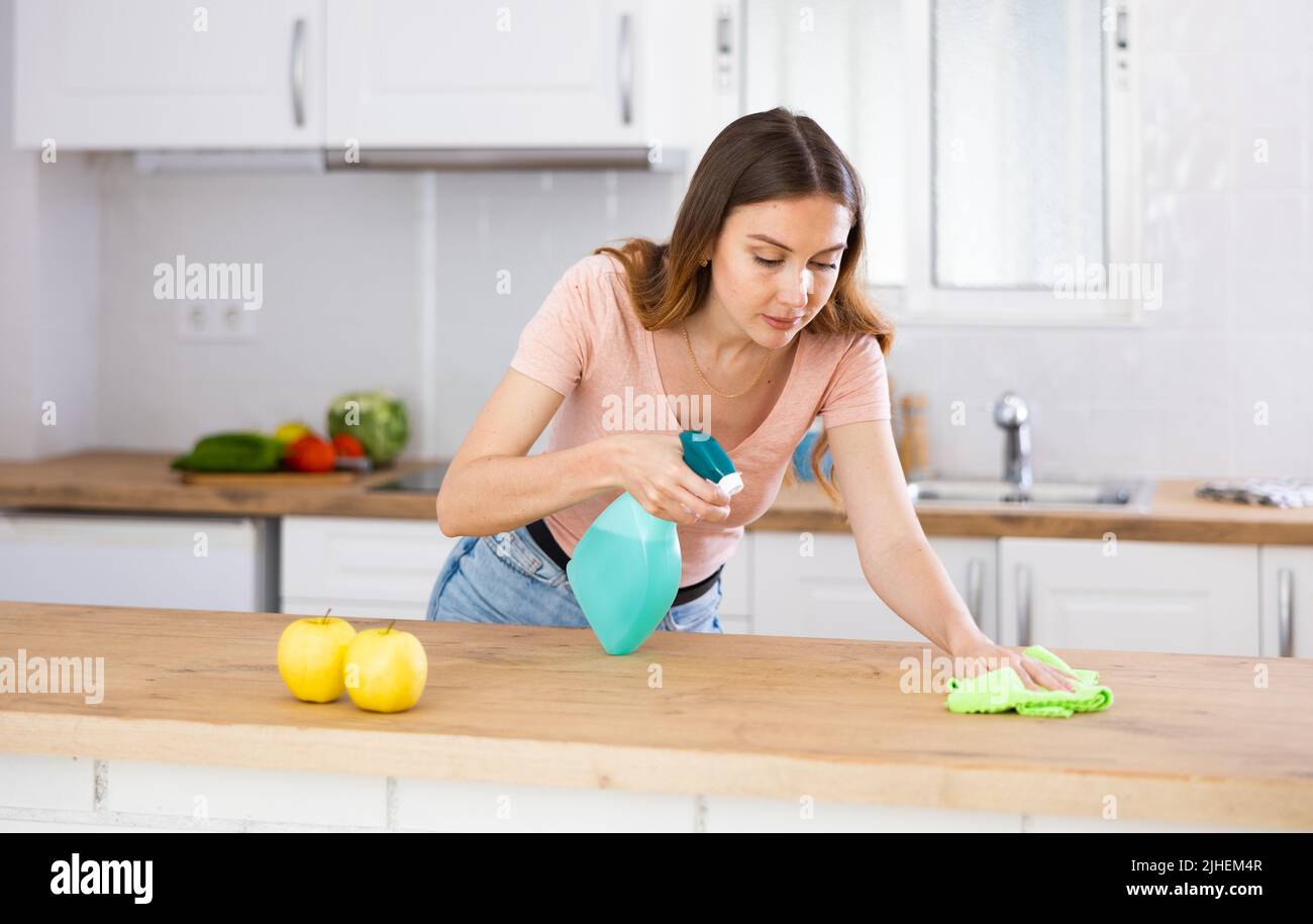 Housewife using rag to wash table Stock Photo - Alamy