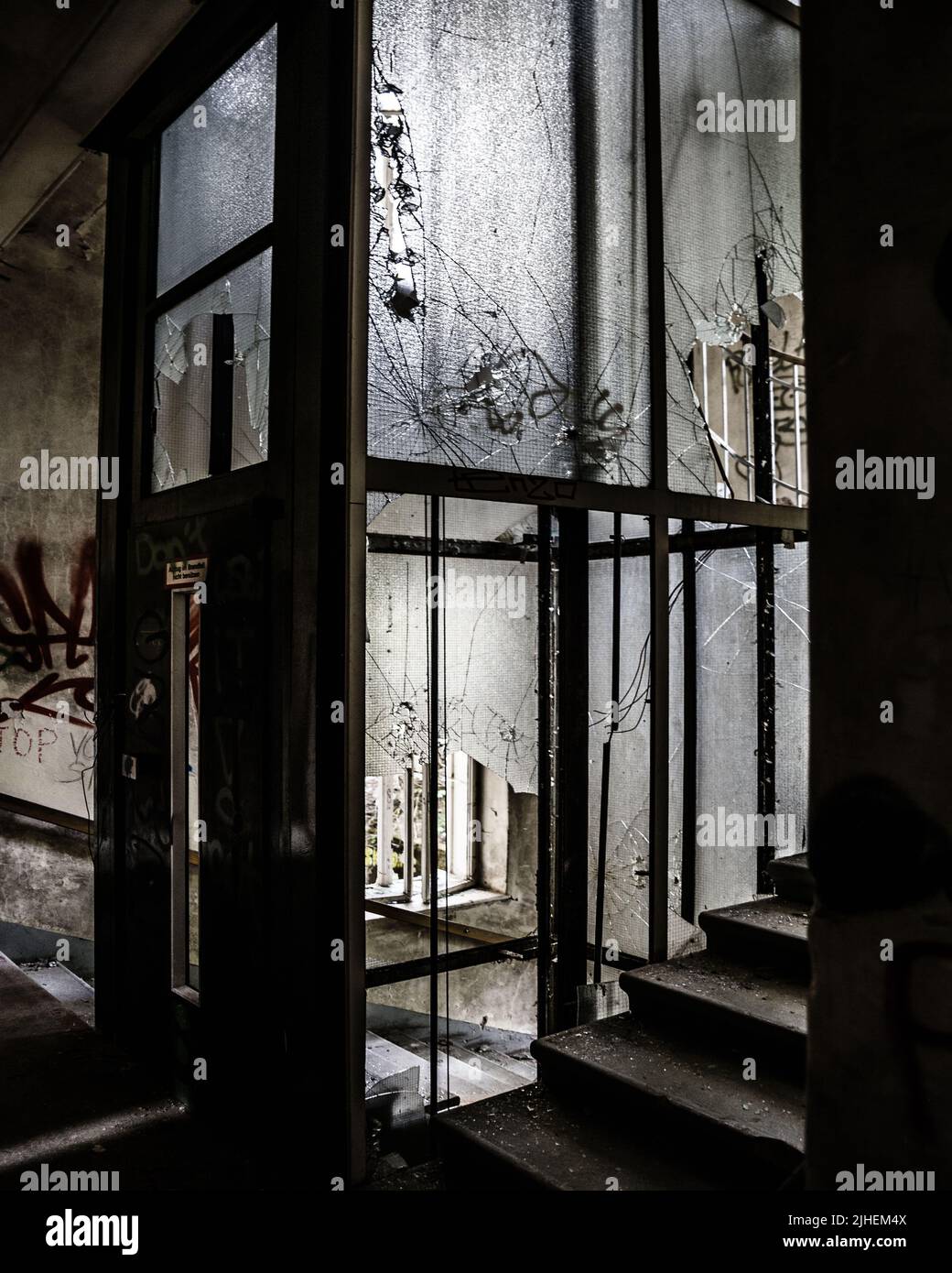 Broken windows and debris are commonplace inside this crumbling ...