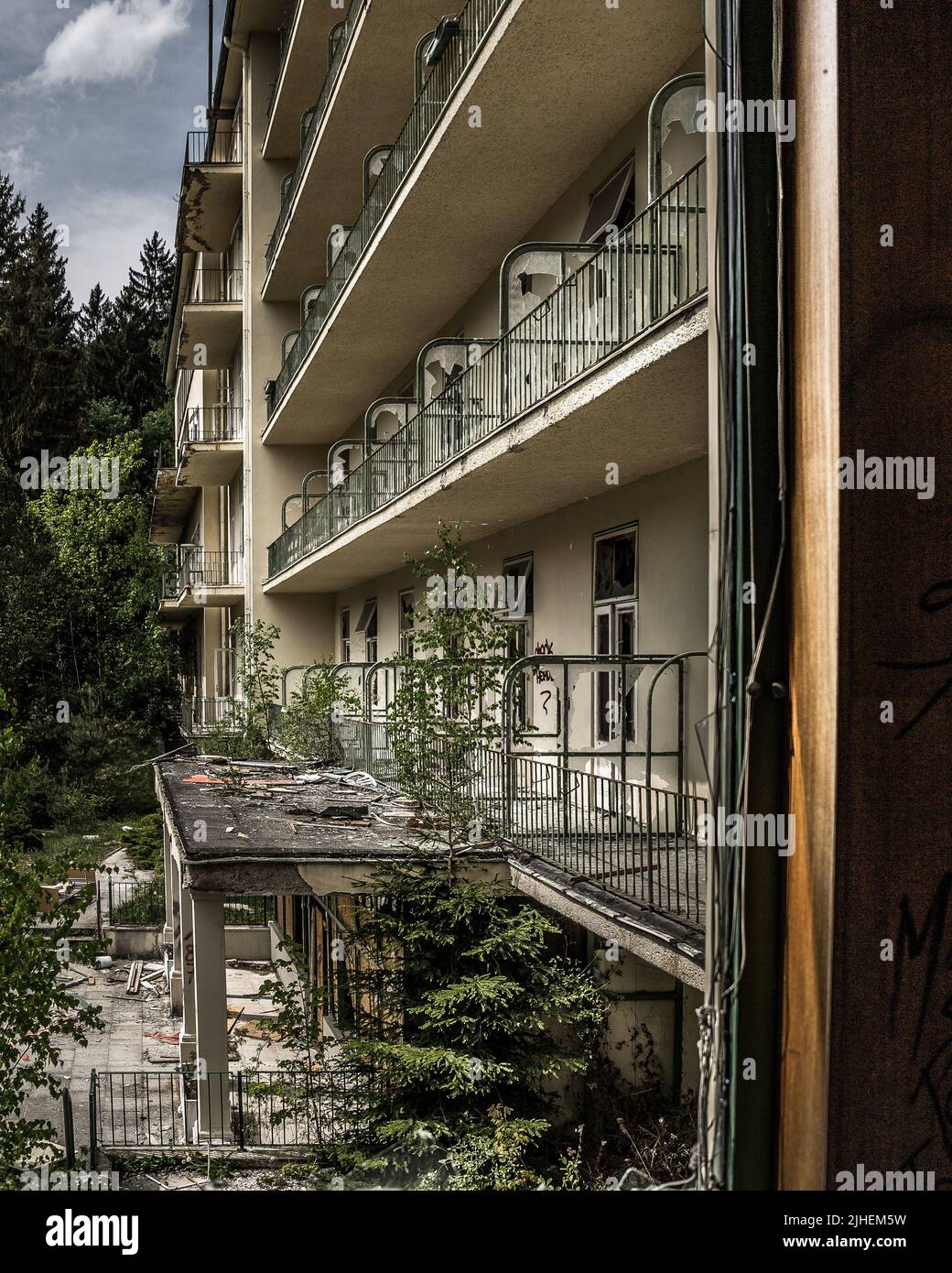 The building stands eerily silent with empty balconies and nature seen ...