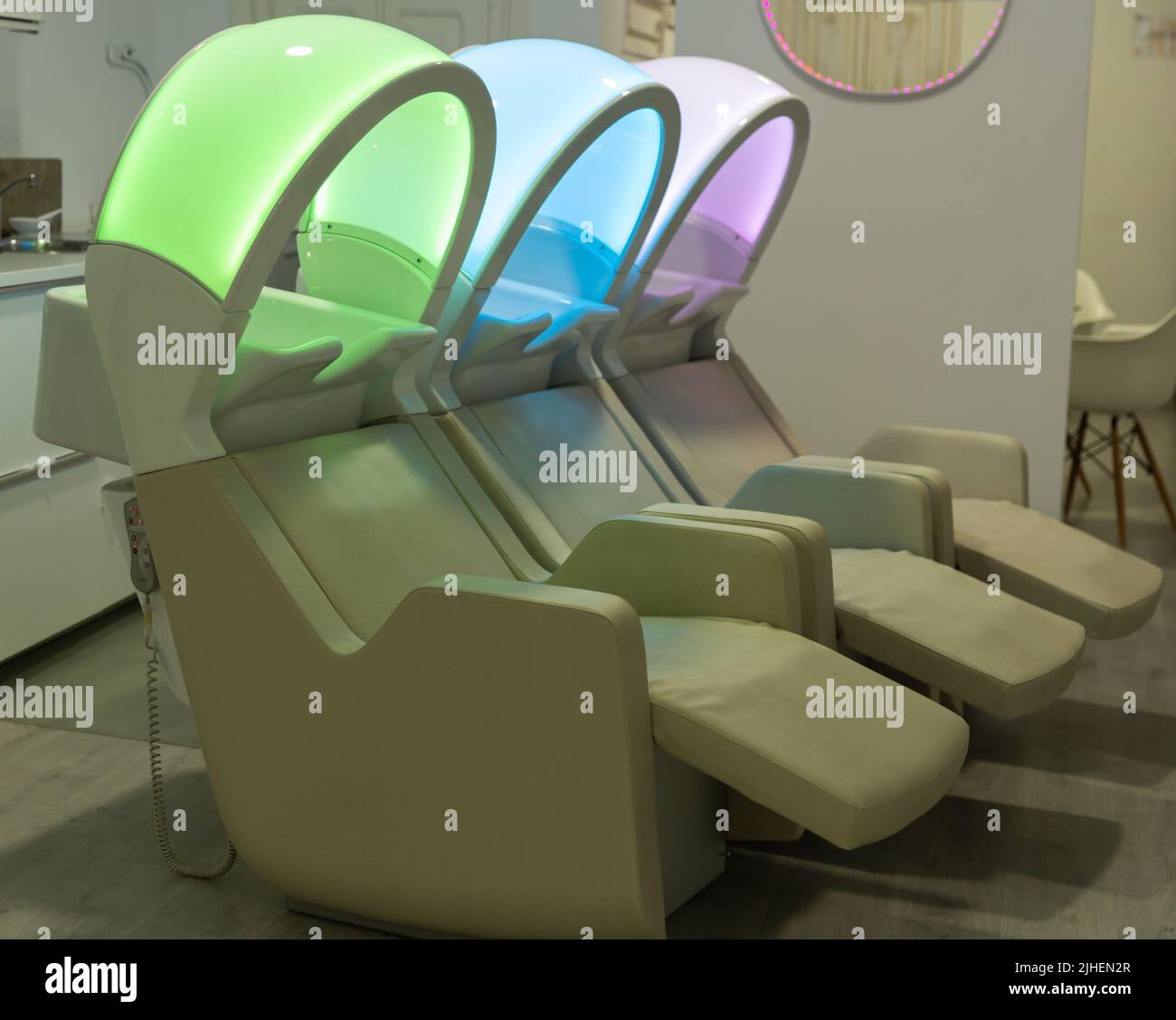 Empty massaging chairs for washing hair in beauty salon Stock Photo - Alamy