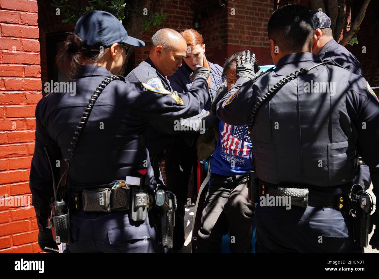 The suspect is arrested by police officers. A man hits people randomly ...