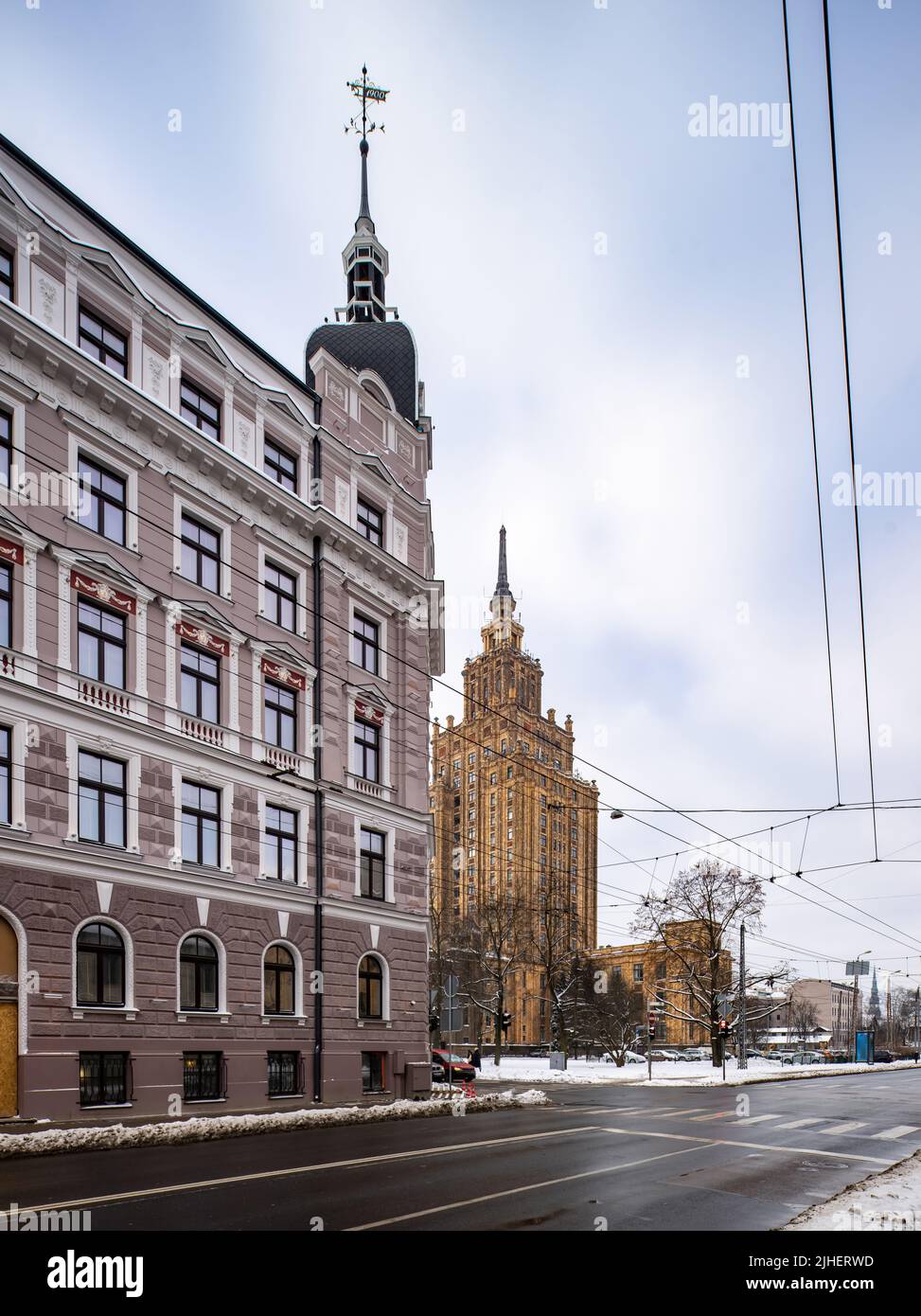 Winter cityscape of Riga. Modern architecture. Snow on road. Cloudy sky ...