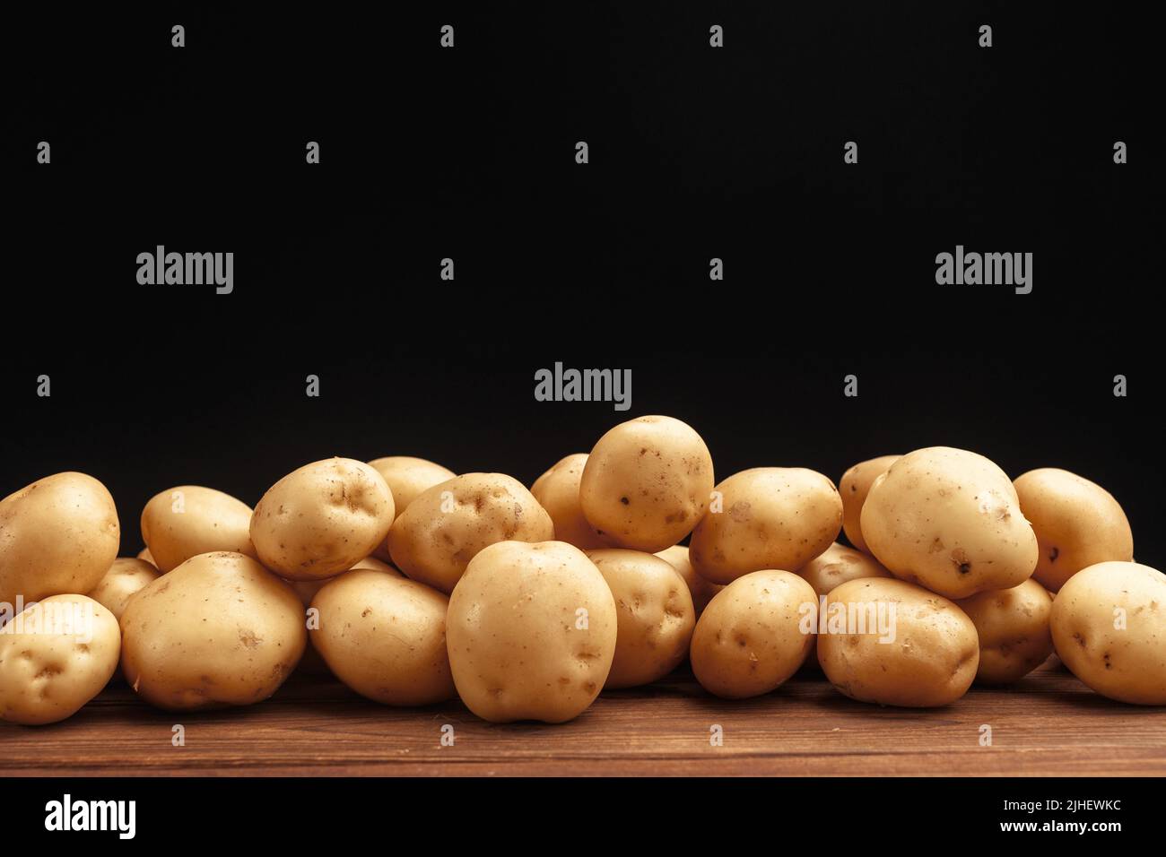 Pile of potatoes lying on wooden boards Stock Photo - Alamy