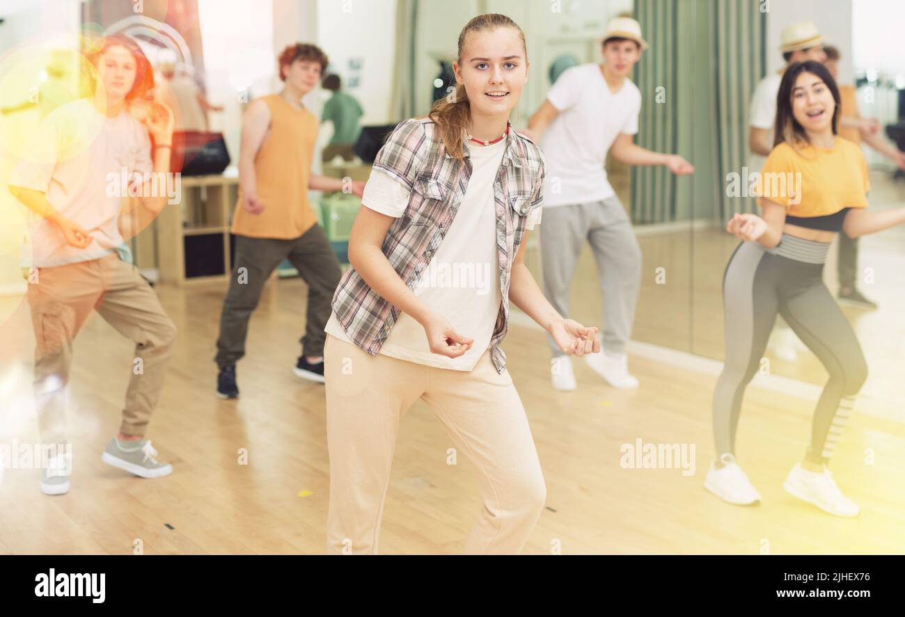 Smiling teenage girl practicing vigorous dance in studio Stock Photo ...