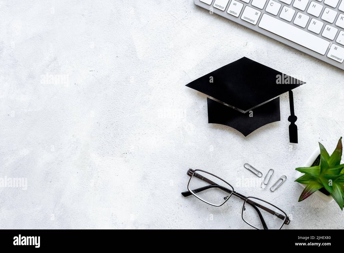 Graduation hat on students table. Masters or Bachelors degree concept ...
