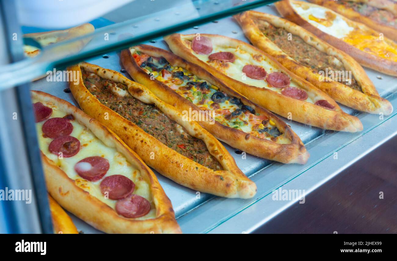 Traditional Turkish pide with various fillings on bakery showcase Stock ...