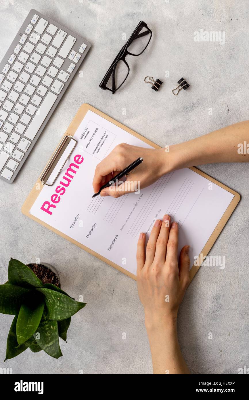 Job seeker filling resume application form on office table Stock Photo ...