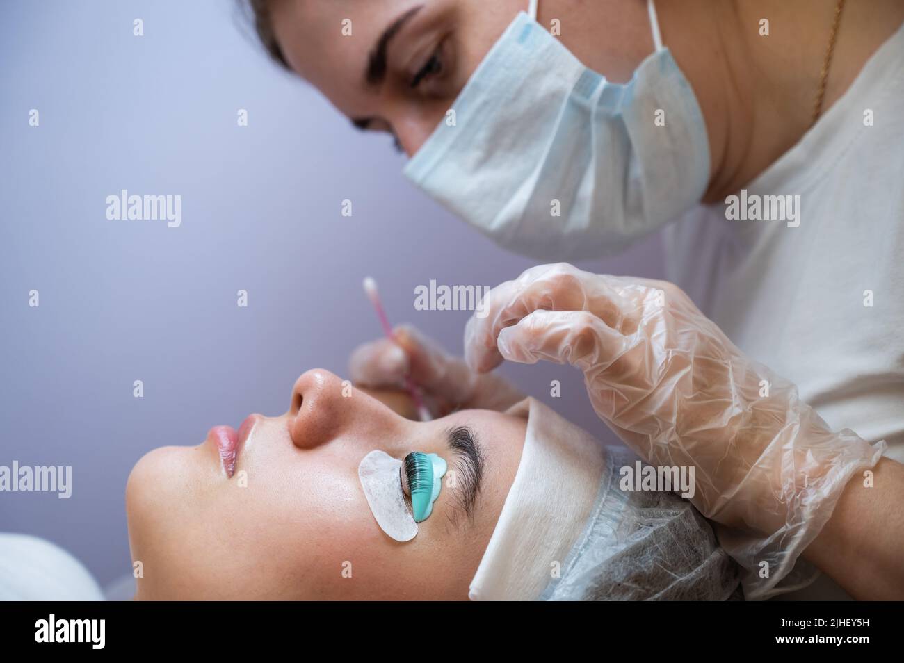The master removes the composition for lamination from the client's ...