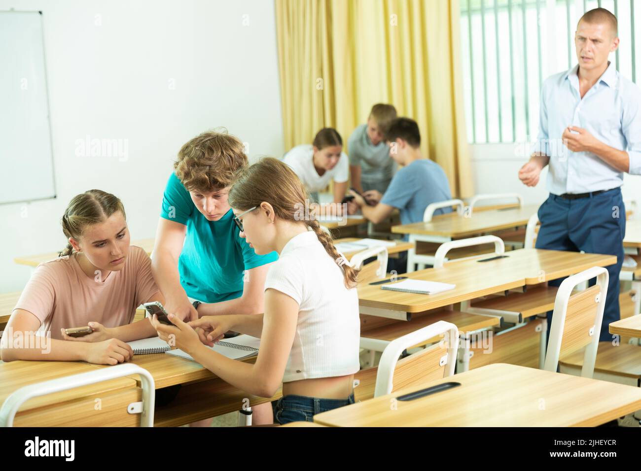 Pupils sitting in class by groups Stock Photo - Alamy