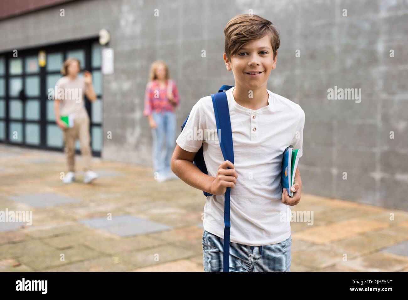 Young boy standing at school building Stock Photo - Alamy