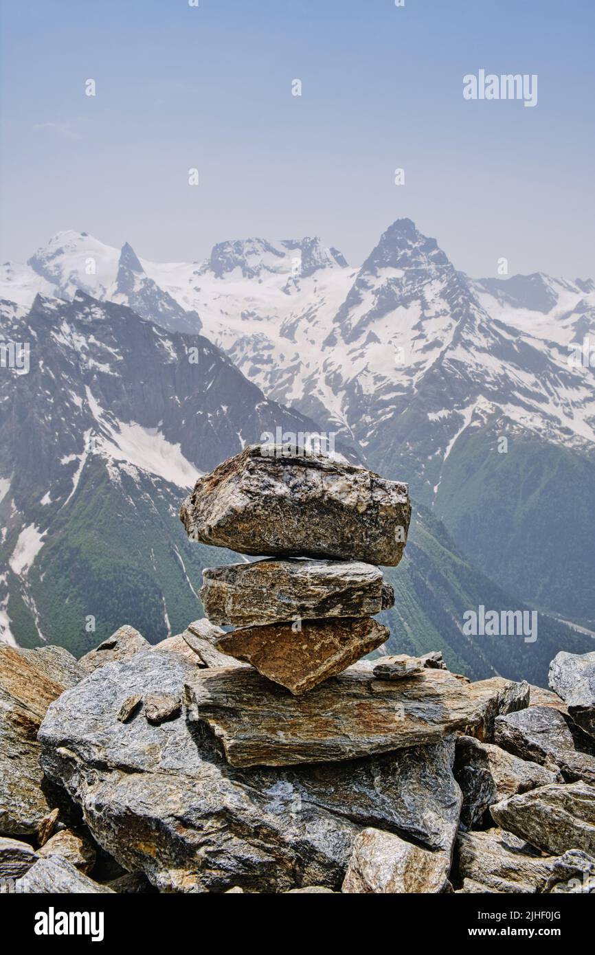 Stack of stones on top of the mountain against a background of mountain ...