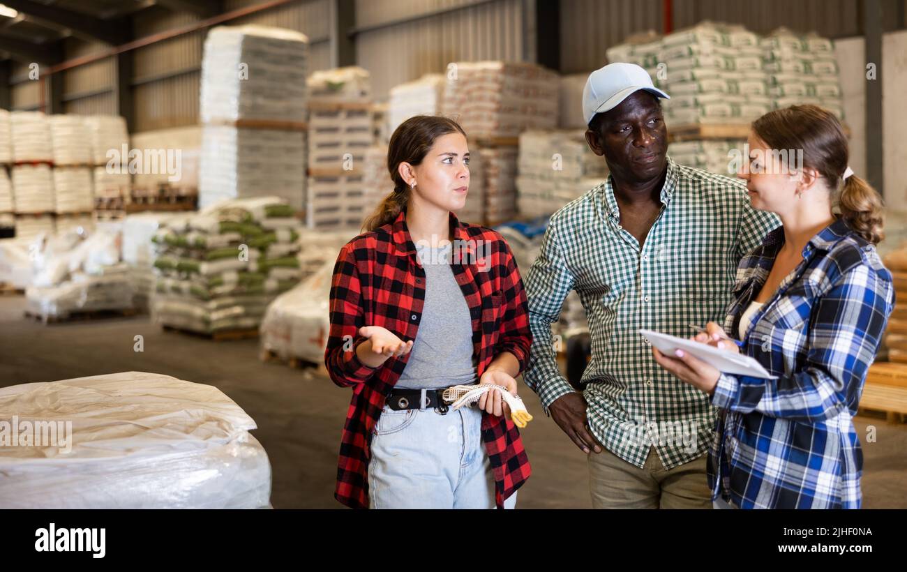 International team of workers checking order list Stock Photo - Alamy