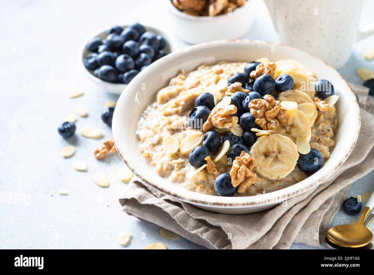Oatmeal porrige in craft bowl at white background Stock Photo - Alamy