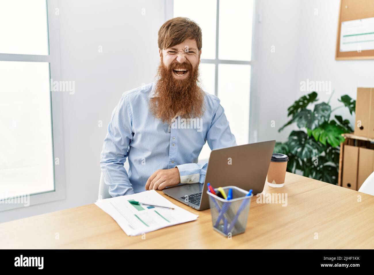 Young irish businessman smiling happy working at the office Stock Photo ...