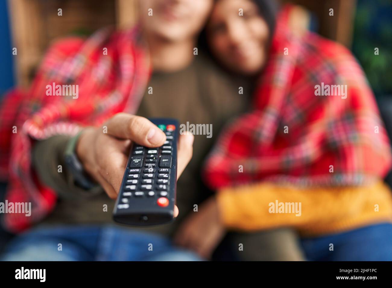 Man and woman couple hugging each other watching tv at home Stock Photo ...