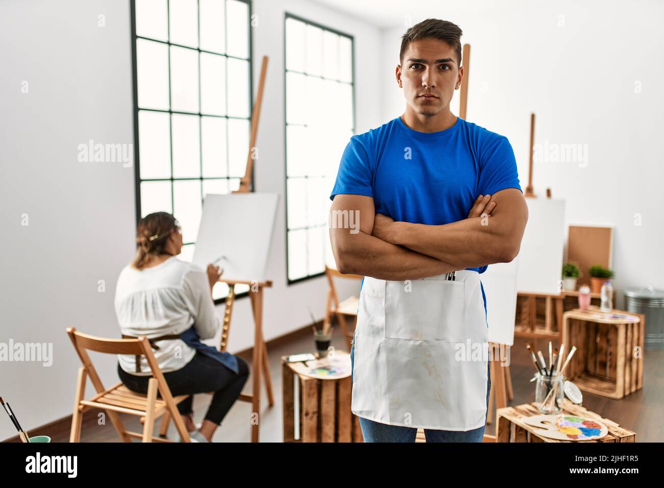 Young hispanic couple at art studio skeptic and nervous, disapproving ... Young hispanic couple at art studio skeptic and nervous, disapproving ...