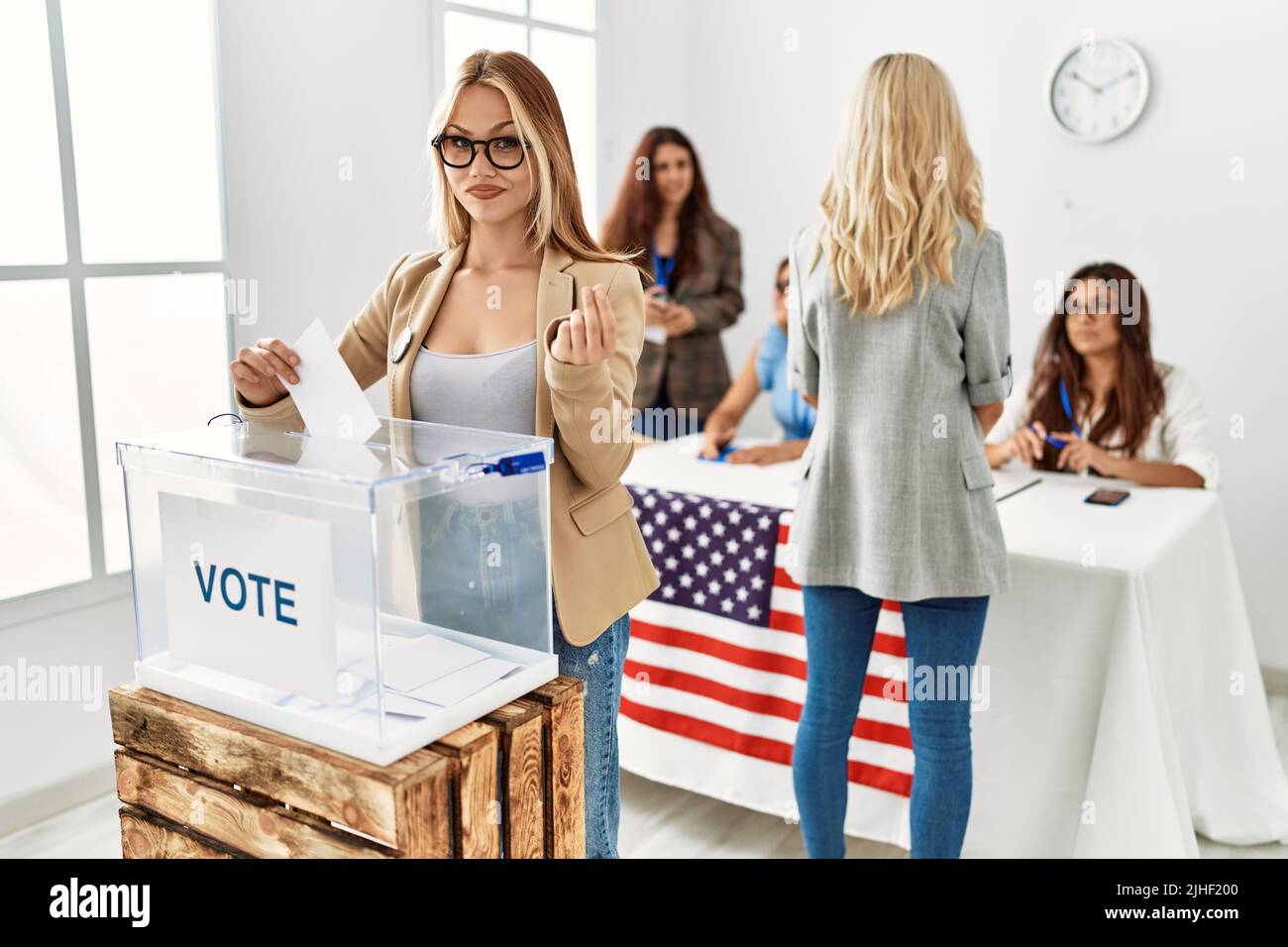 Group of young girls voting at democracy referendum doing money gesture ...